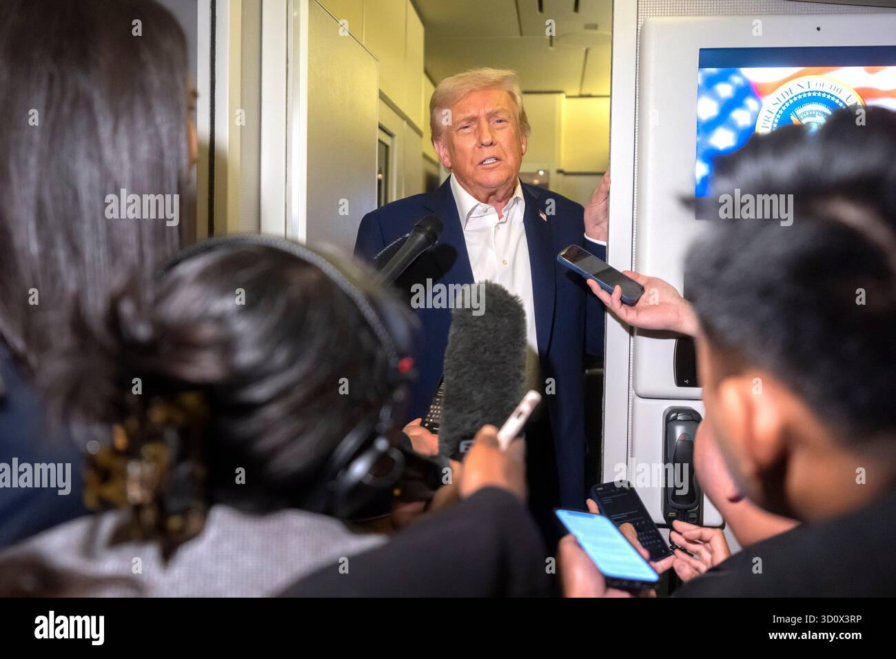 President Donald Trump speaks to reporters aboard Air Force One en ...