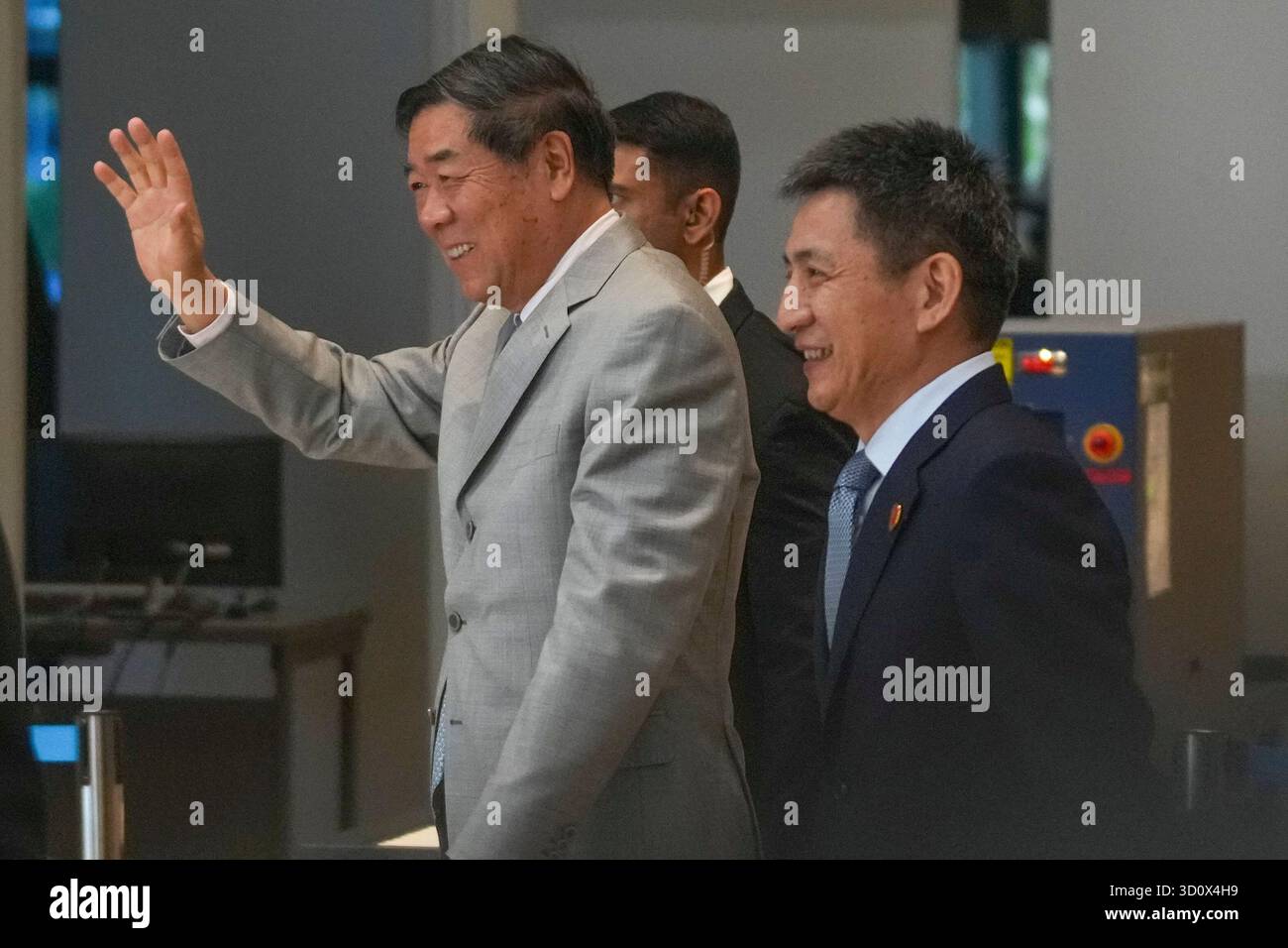 Chinese Vice Premier He Lifeng, left, waves to the media as he along ...