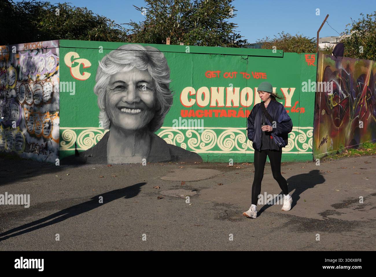 A person walks past a mural of Catherine Connolly by artist Emmalene ...