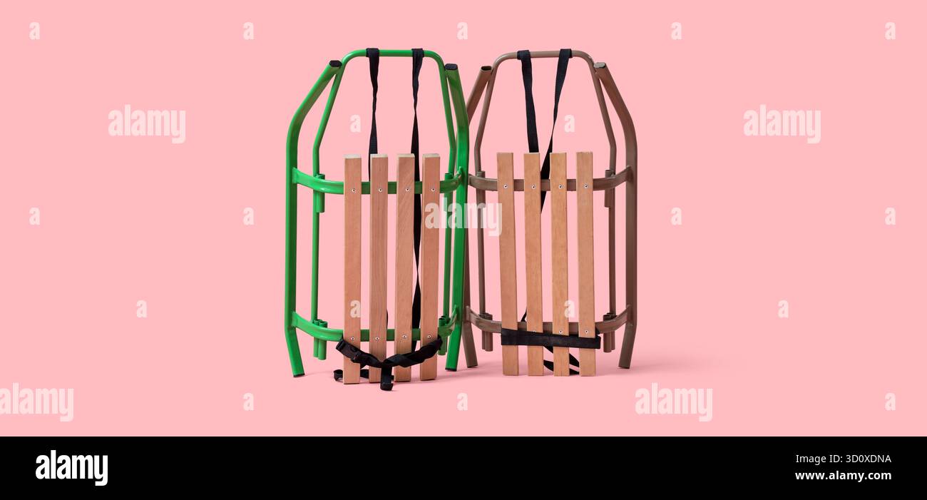Empty sleds on pink background Stock Photo - Alamy