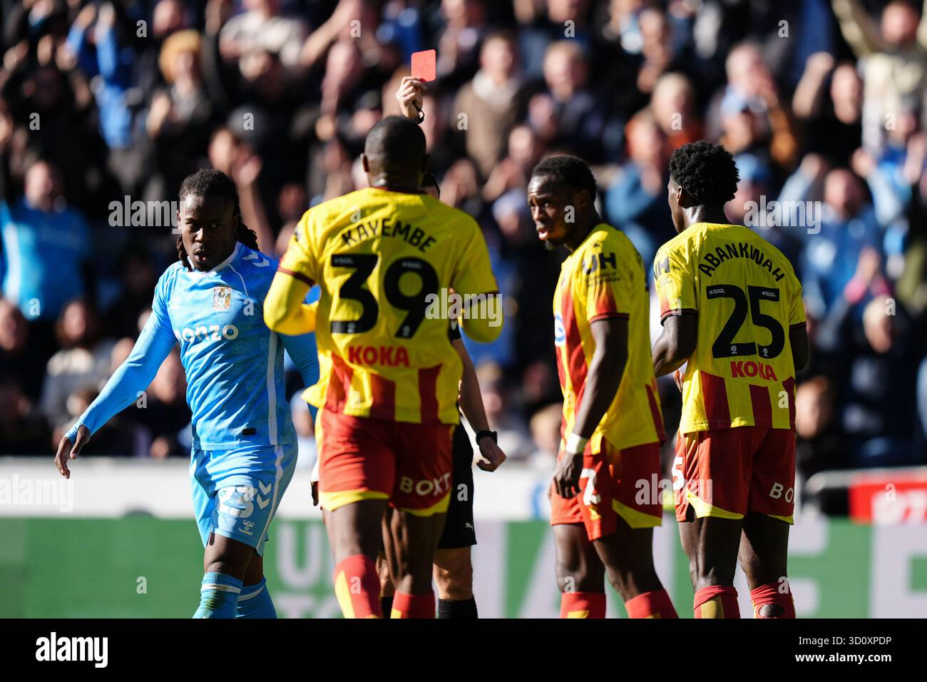 Watford's James Abankwah (right) is shown a red card by referee Dean ...