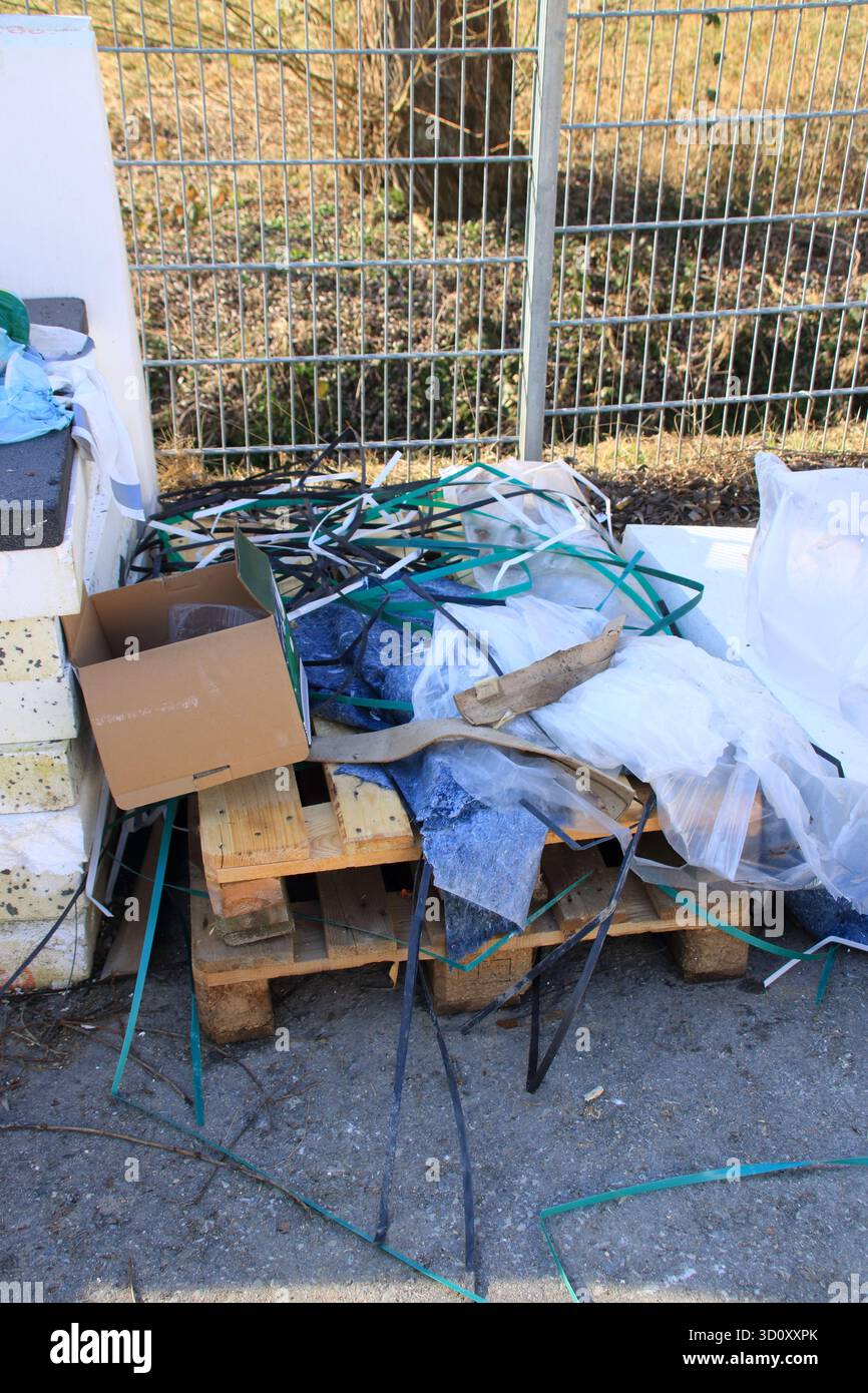 Plastic and cardboard waste lie on a pallet Stock Photo - Alamy
