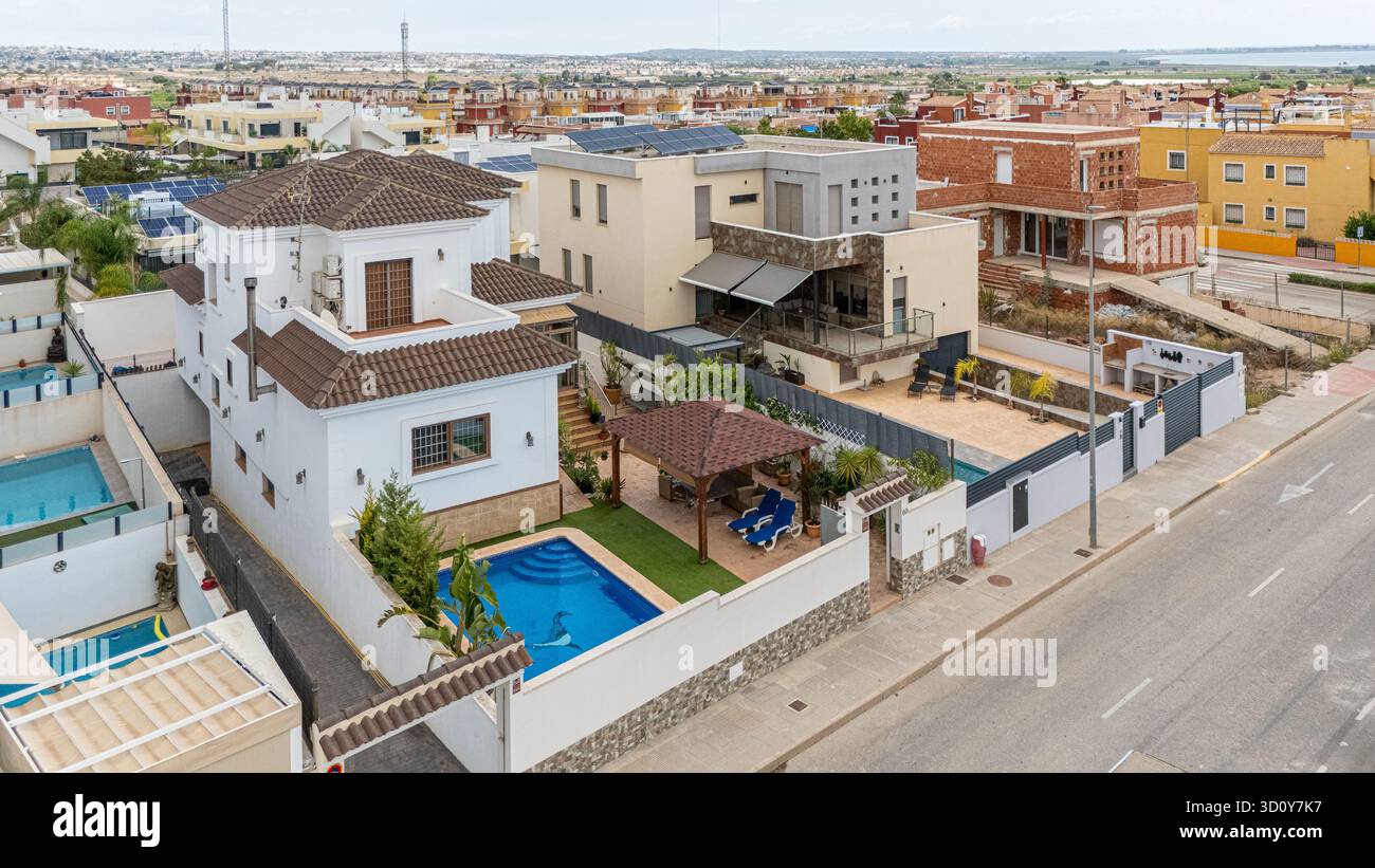 Elevated perspective of a white villa with a brown tiled roof ...