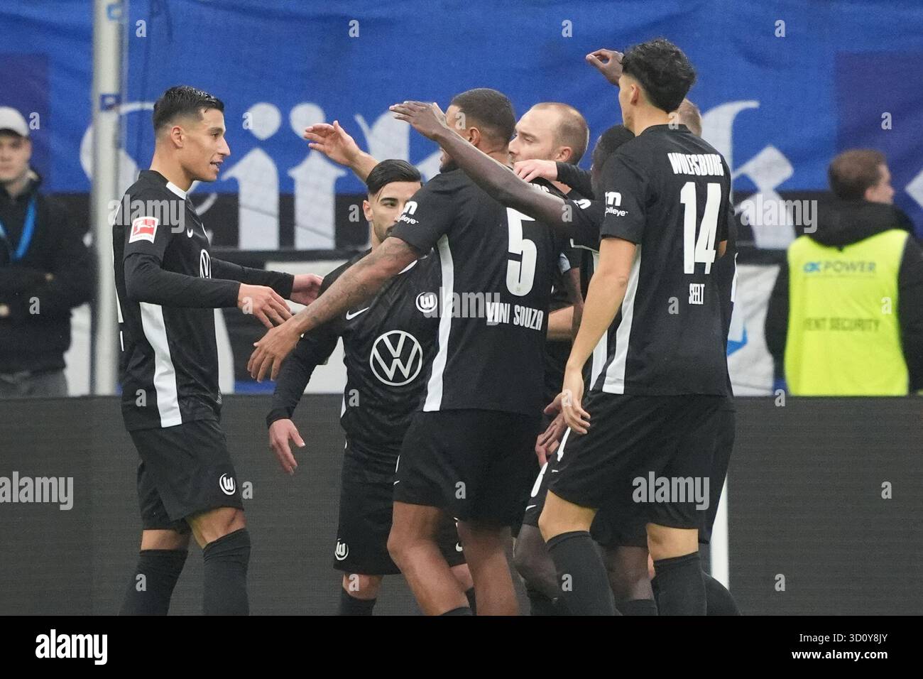 Wolfsburg's Adam Daghim, left, celebrates scoring with teammates during ...