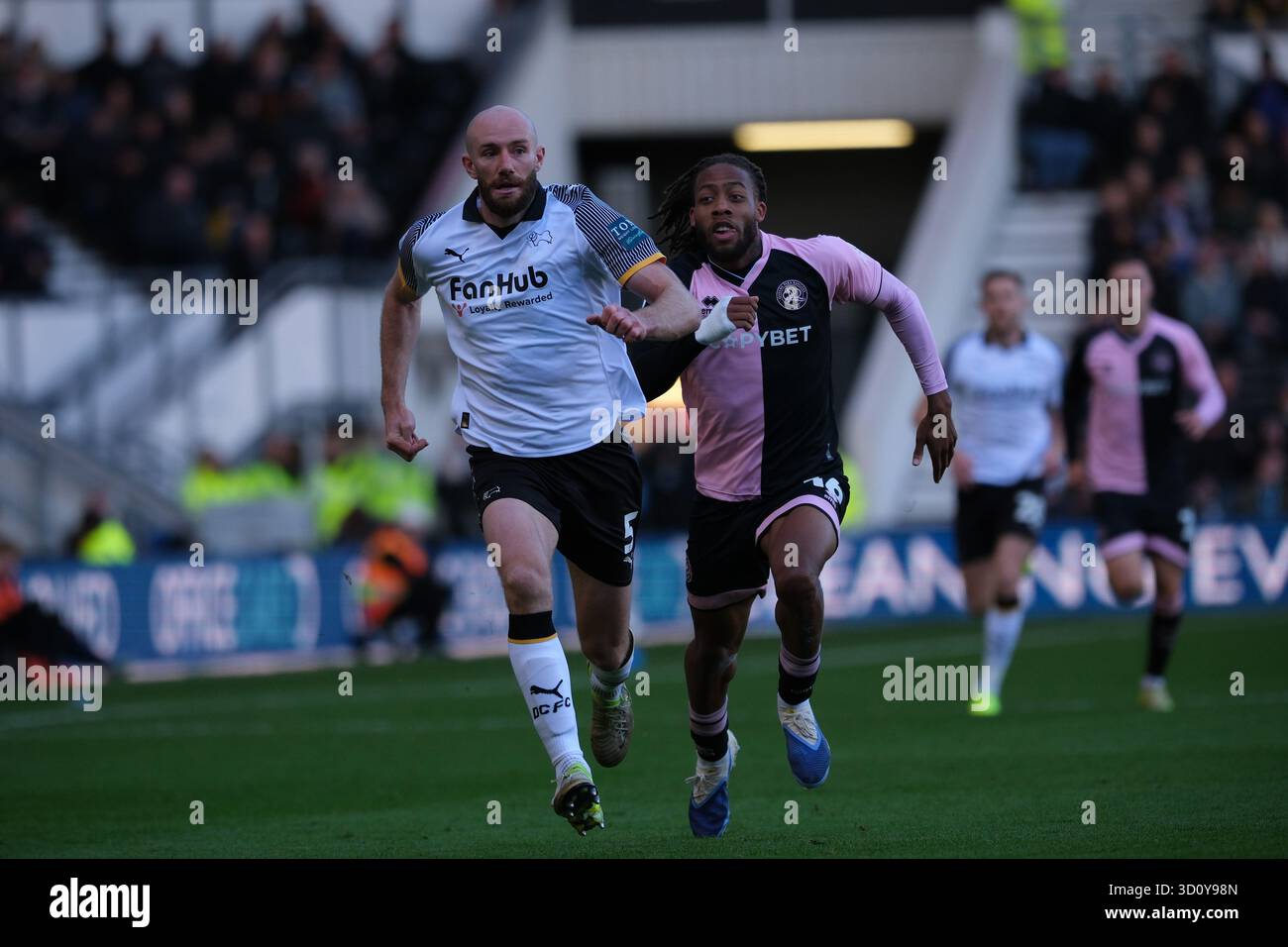 Rumarn Burrell of Queens Park Rangers challenges for the ball against ...