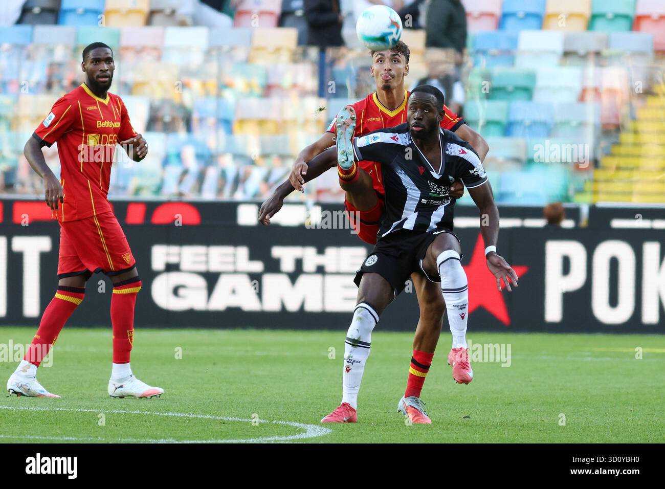 Udinese's Keinan Davis and Lecce's Tiago Gabriel, top, eye the ball ...