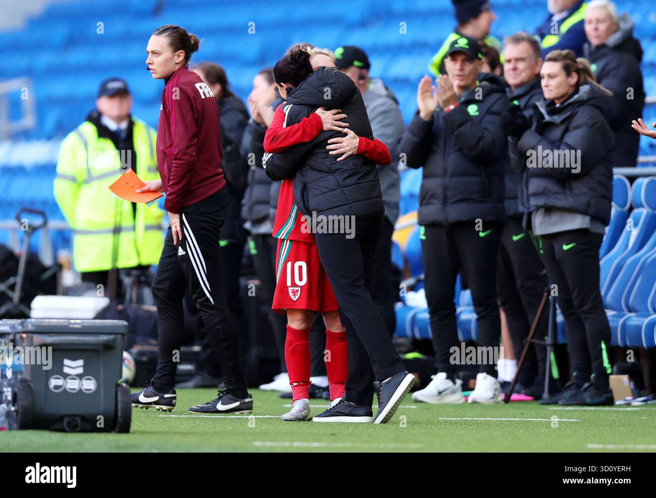 Jess Fishlock is embraced by manager Rhian Wilkinson (centre left ...