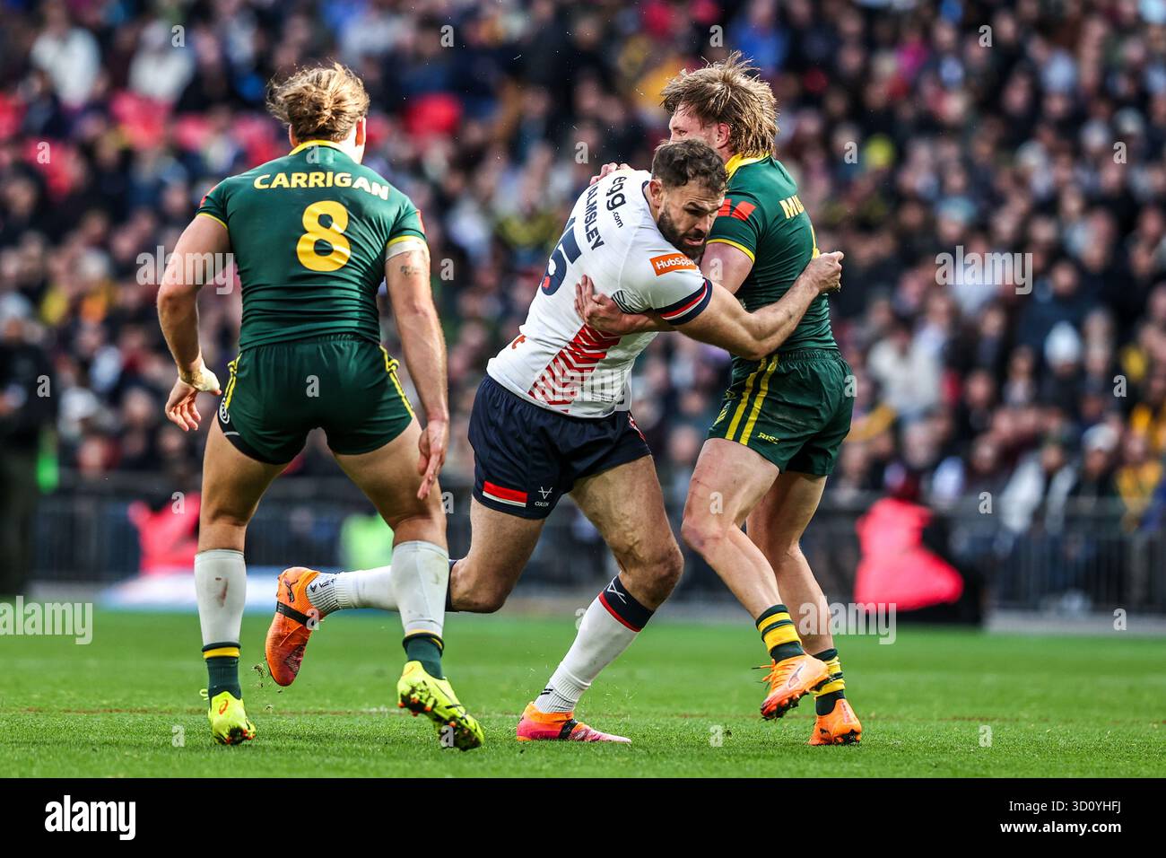 Alex Walmsley of England is tackled by Patrick Carrigan of Australia ...