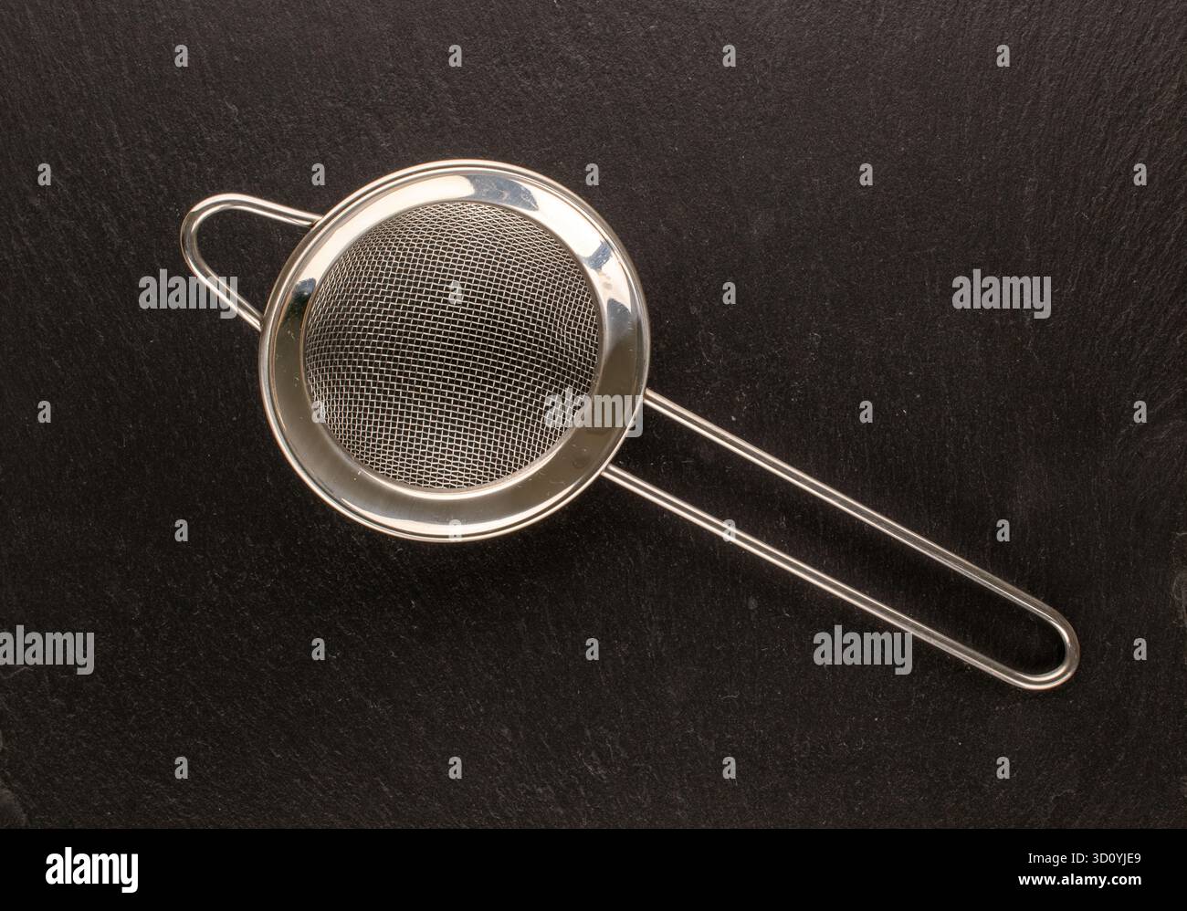 Metal kitchen sieve on slate stone, top view Stock Photo - Alamy
