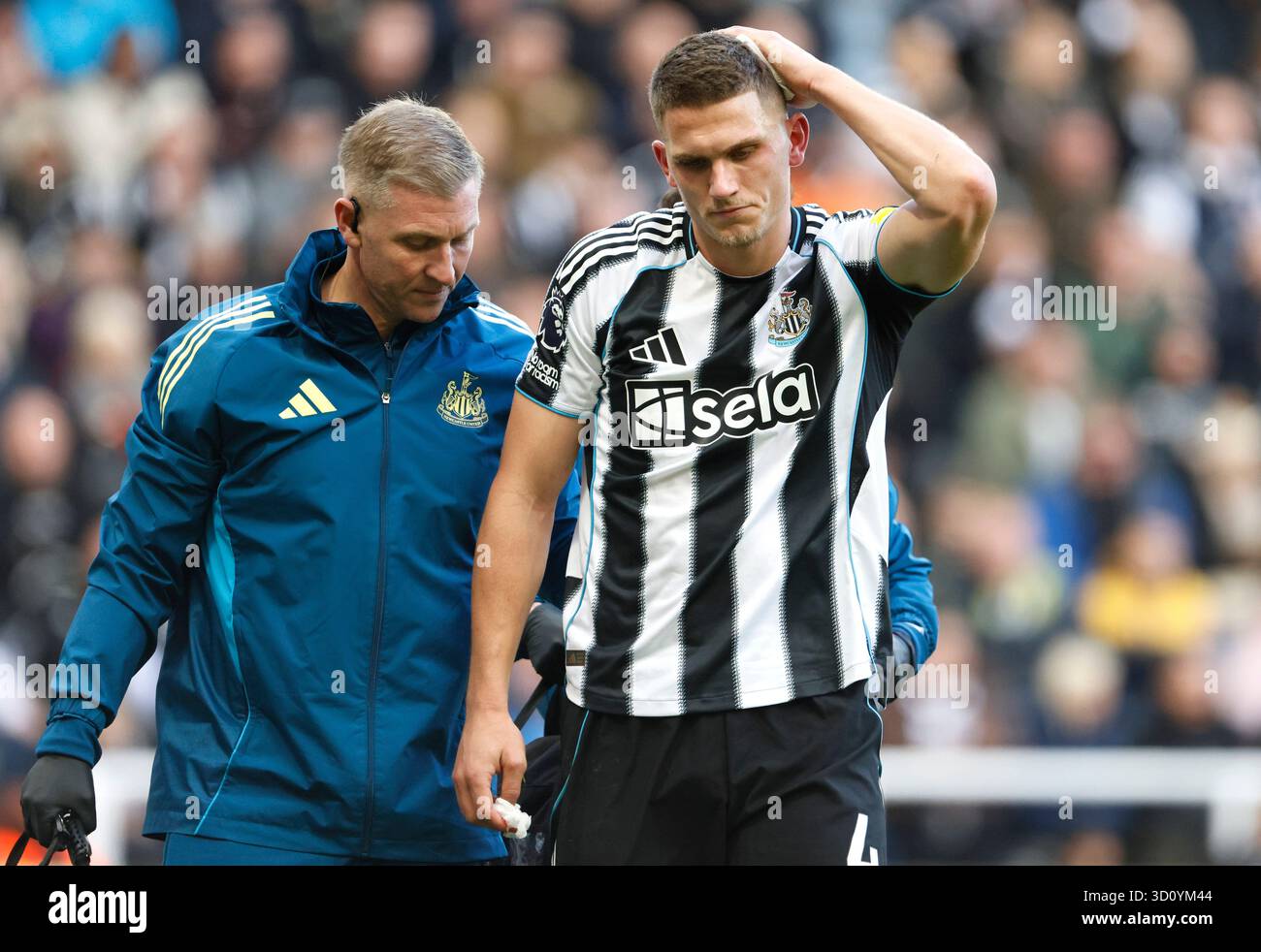 Newcastle United's Sven Botman walks off the field with the medical ...