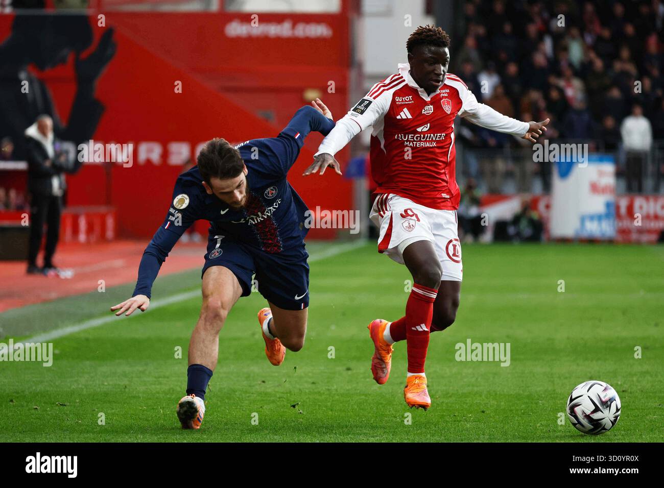 PSG's Khvicha Kvaratskhelia, left, challenges for the ball with Brest's ...