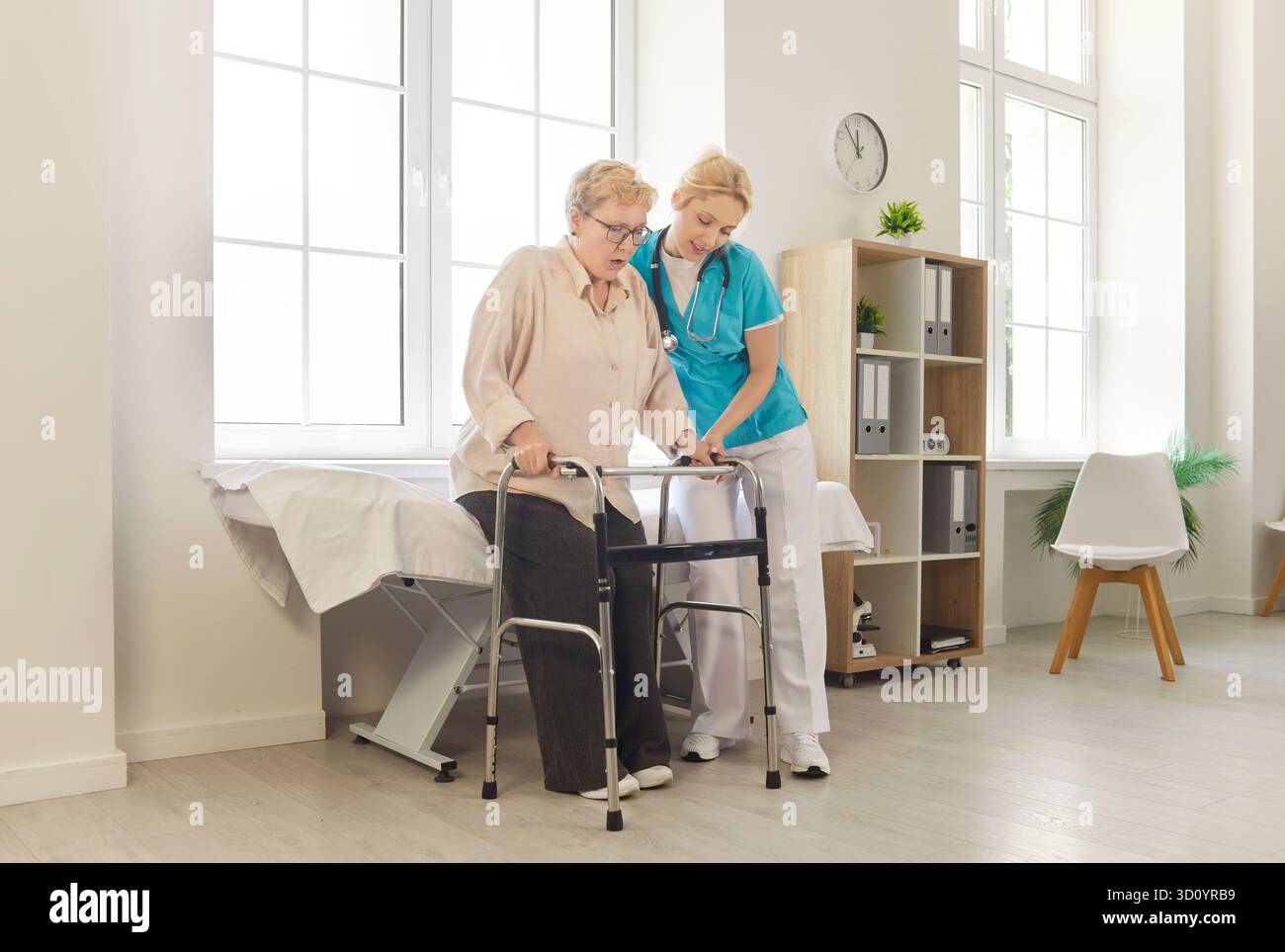 Nurse helping senior patient safe walking, using walker in medical ...