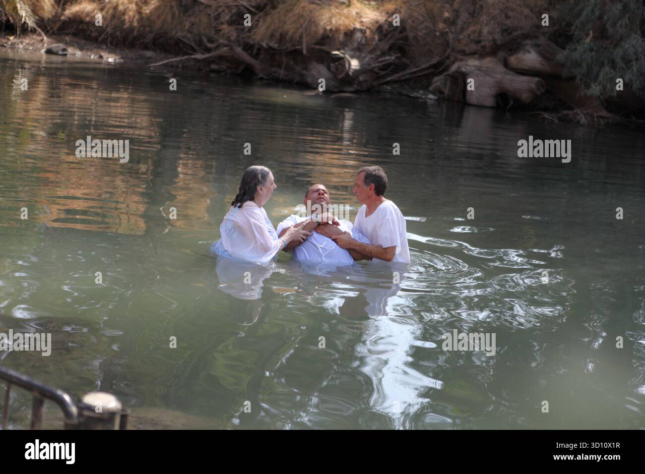 Evangelical American man wearing a white gown being pushed by a pastor ...