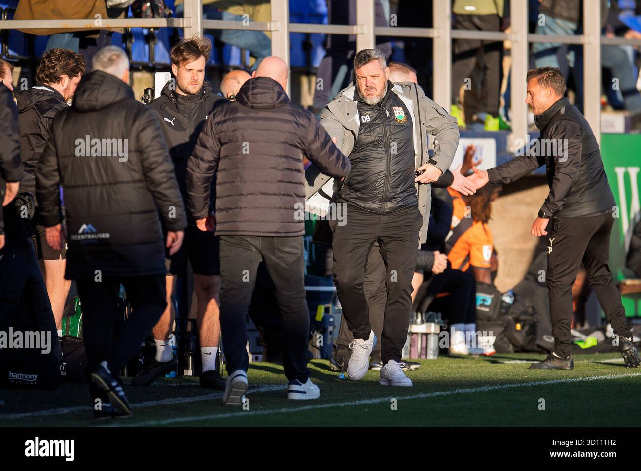 Barnet manager Dean Brennan shakes hands with Barrow manager Andy Whing ...