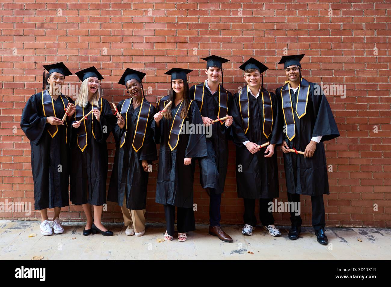 Diverse college graduates holding diplomas celebrating success Stock ...