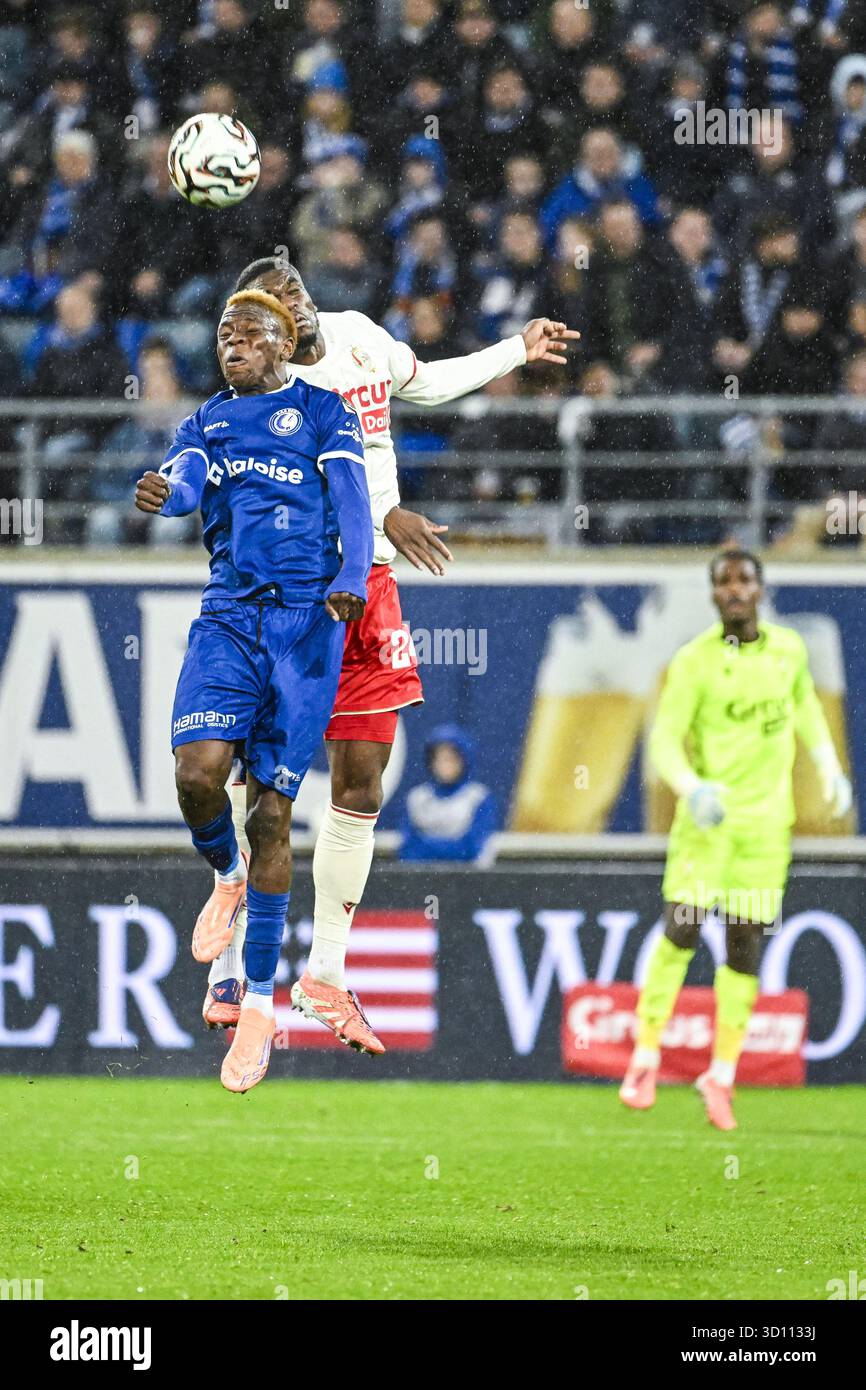 Gent's Hyllarion Goore and Standard's Josue Homawoo pictured in action ...