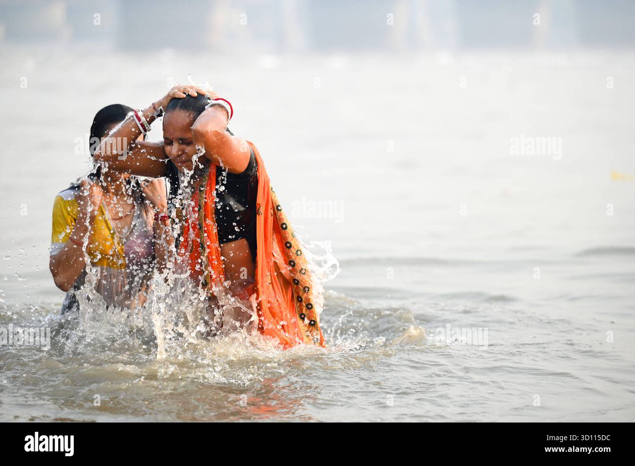 NOIDA, INDIA - OCTOBER 25: Devotees perform puja and bathe in the ...