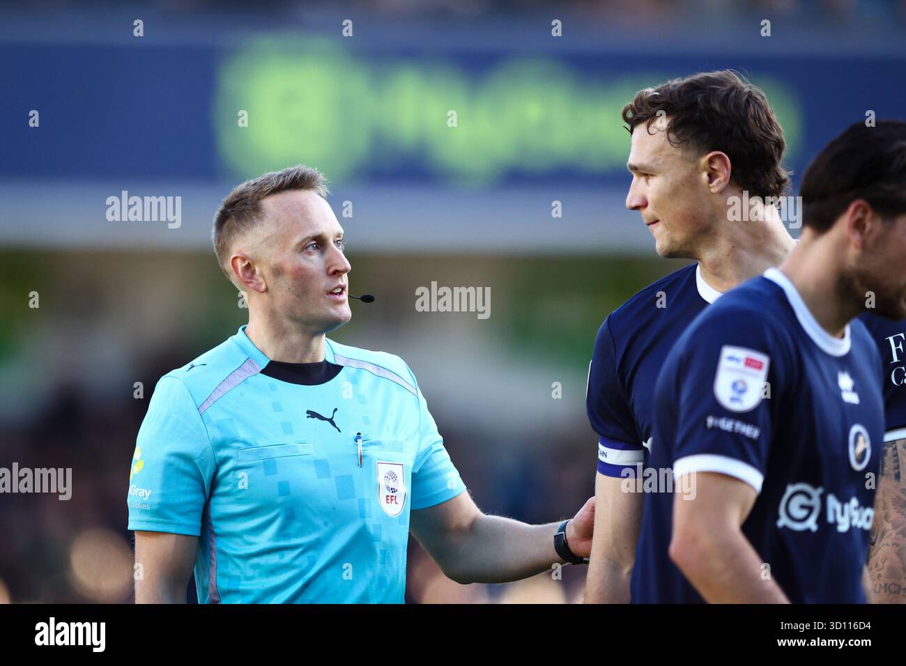 Referee James Bell talks to Millwall captain Jake Cooper during the Sky ...