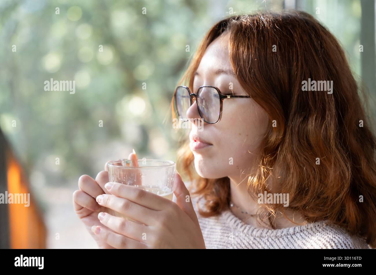 Young woman enjoying a cup of tea in the terrace of a cabin Stock Photo ...