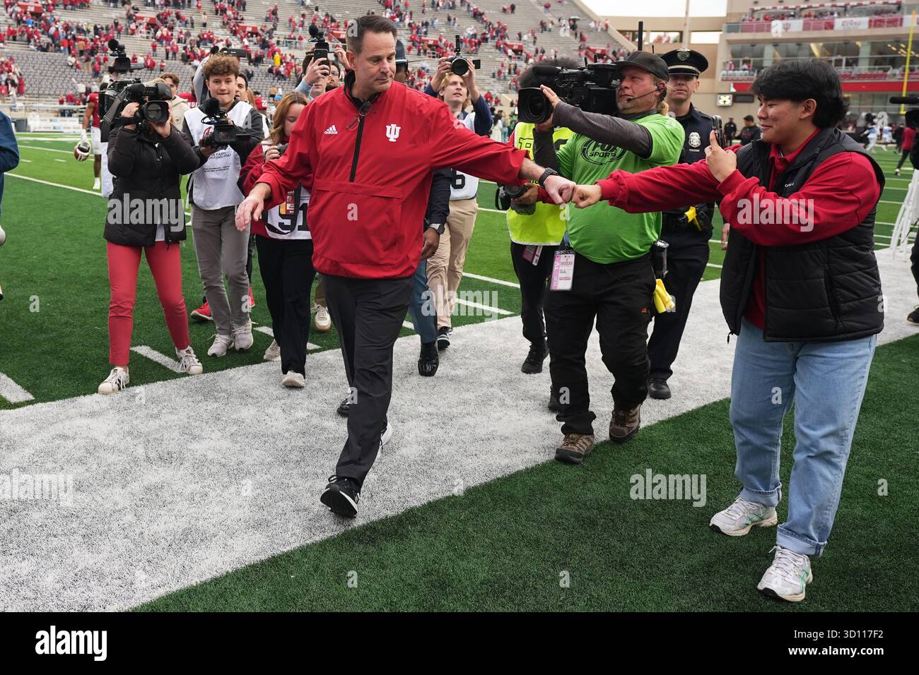 Indiana head coach Curt Cignetti fist bumps a fan as he leaves the ...