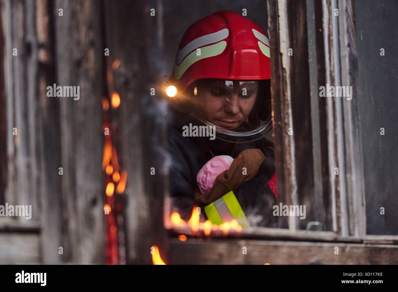 Firefighter rescuing a baby from burning building, fireman in action ...