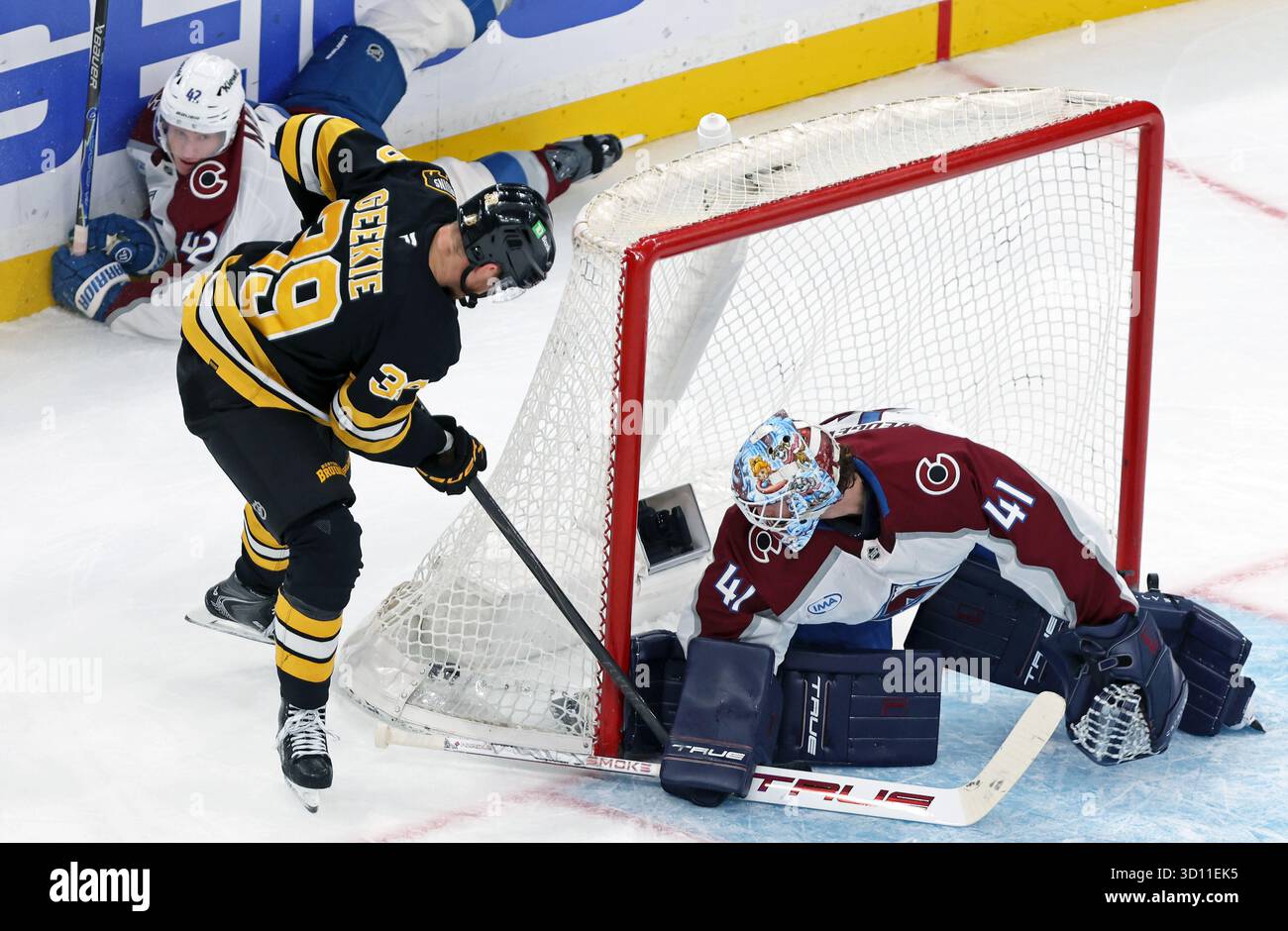 Boston Bruins forward Morgan Geekie stuffs the puck past Colorado ...