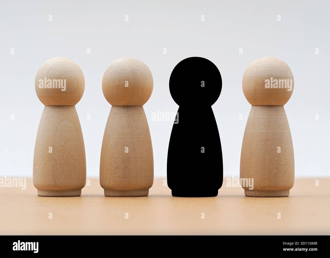 Four wooden figures stand in a row, highlighting diversity. Three ...