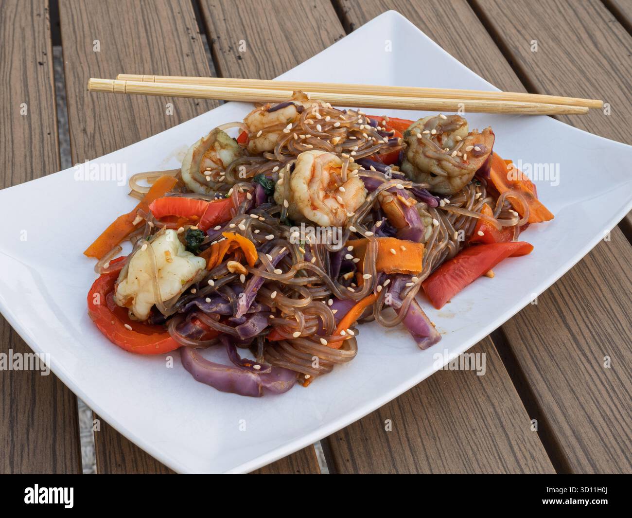 A balanced composition of a shrimp and rice noodle stir-fry with ...