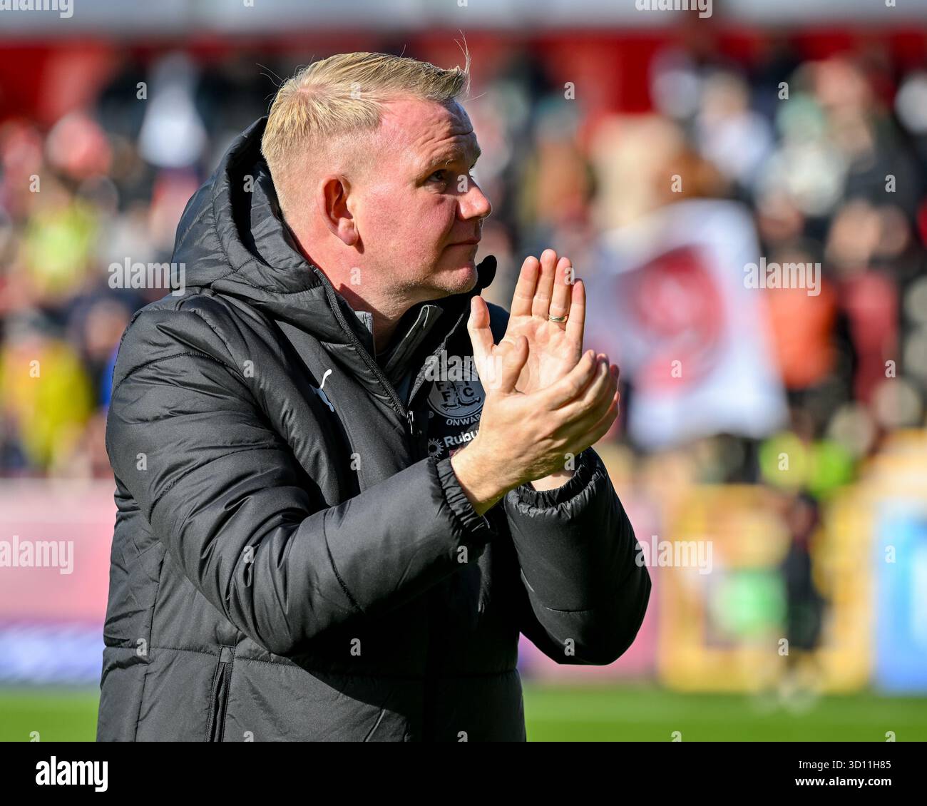 Pete Wild, manager of Fleetwood Town, clap the home supporters during ...
