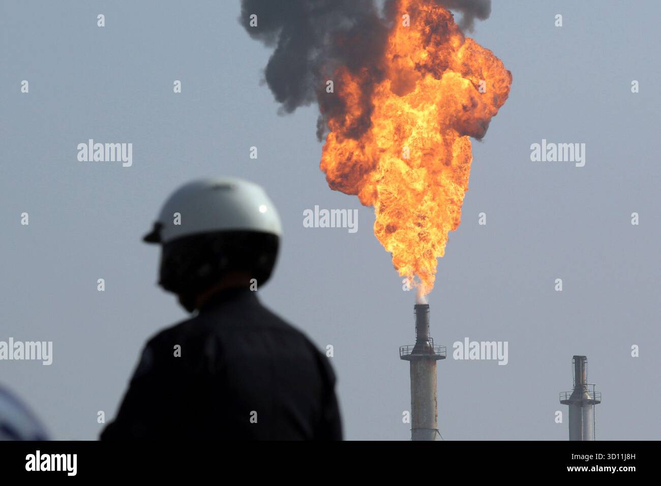 FILE - A very large smokestack flare burns off flammable product after ...