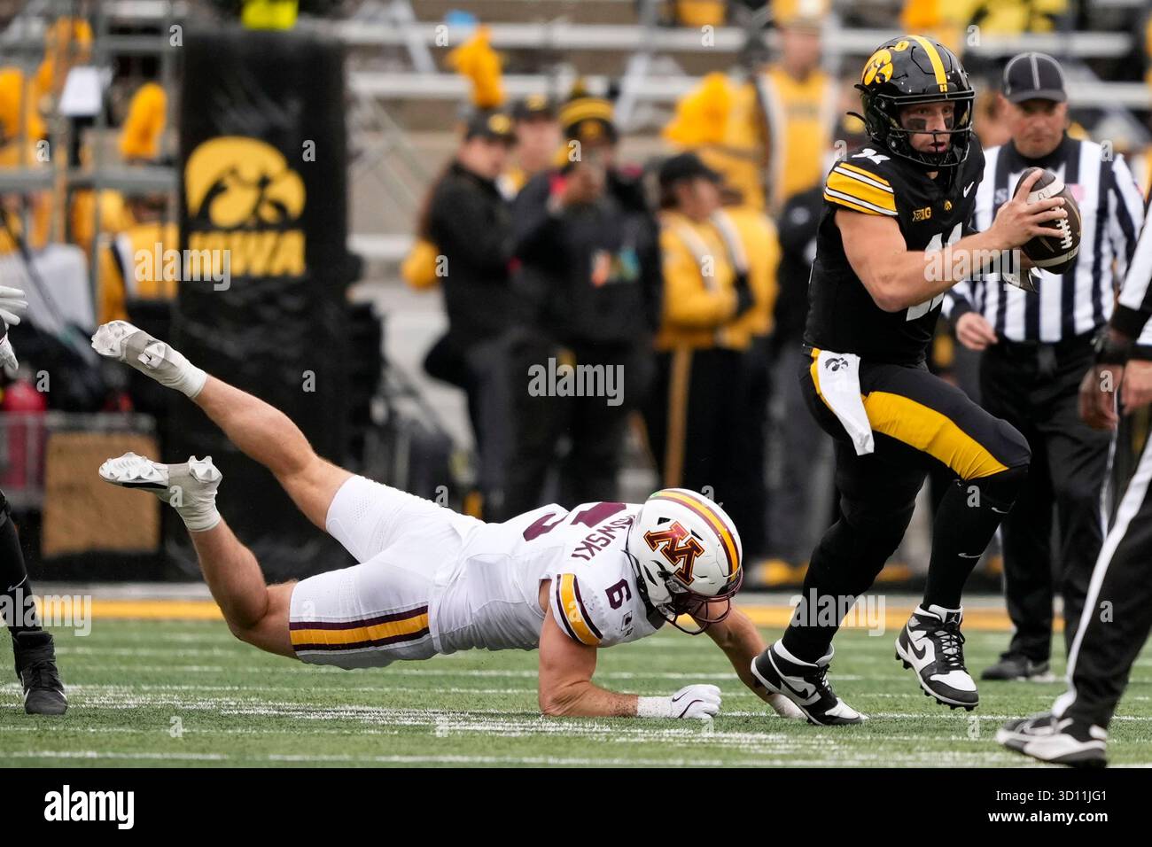 Iowa quarterback Mark Gronowski (11) runs from Minnesota linebacker ...