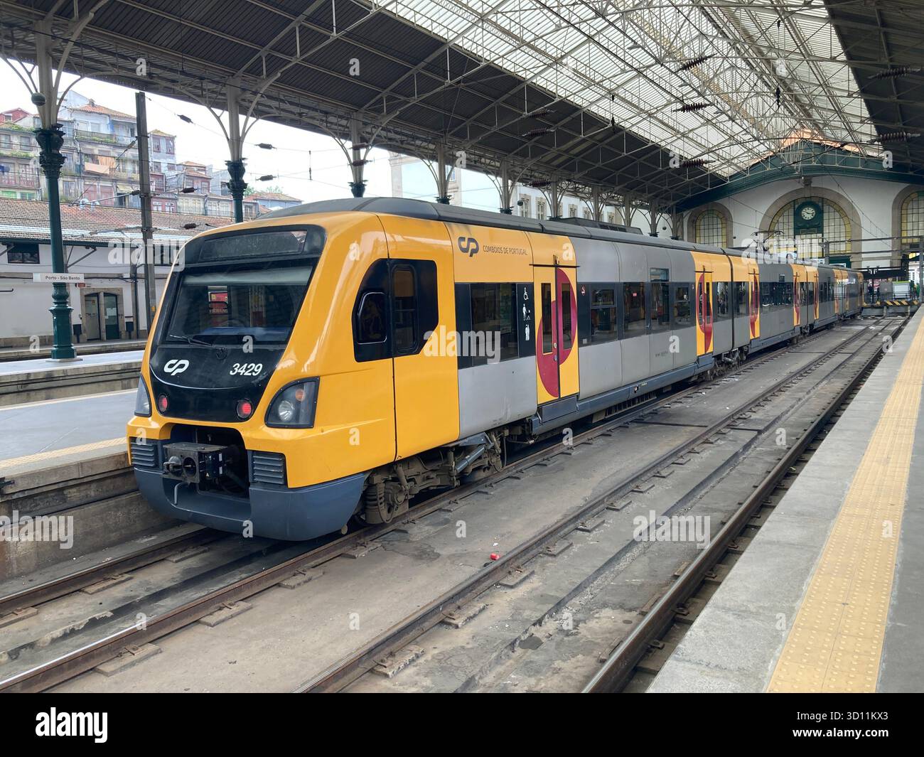 Light rail tram of Porto Metro system navigating streets and tracks in ...