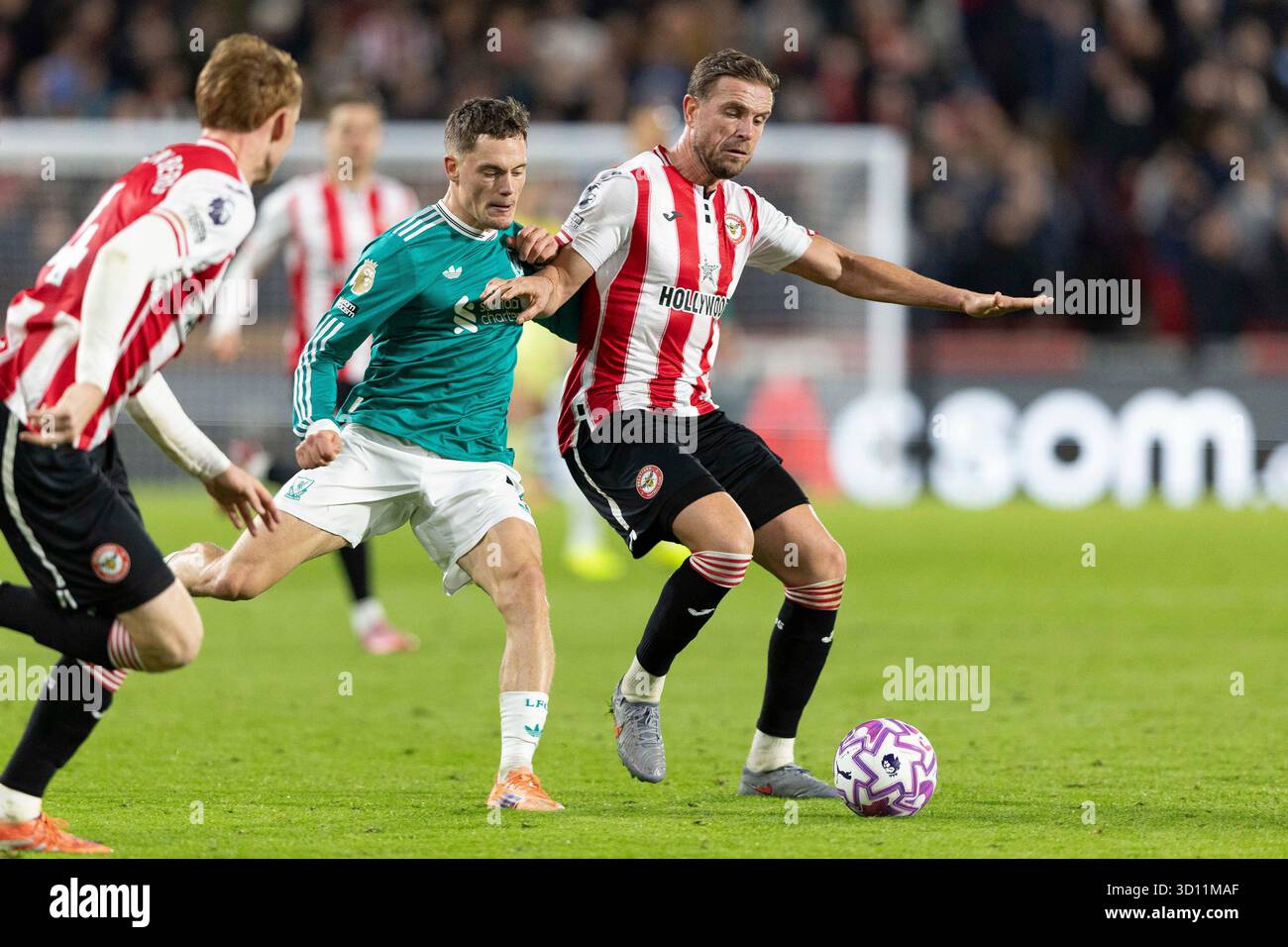 Jordan Henderson of Brentford tackles Florian Wirtz of Liverpool during ...
