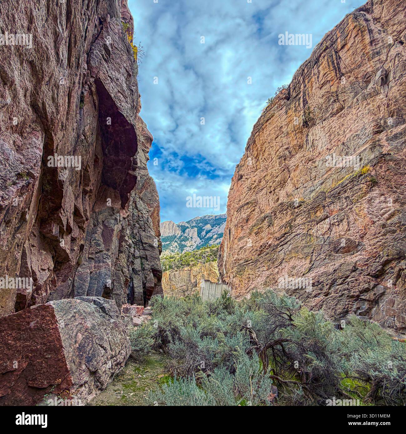A gap between high mountain cliffs forms a natural opening to enter and ...