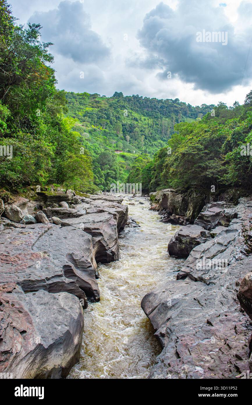 A scenic view of the Magdalena River flowing through rocky landscapes ...