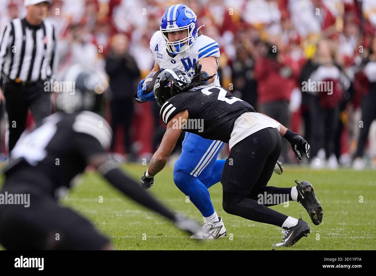 BYU tight end Carsen Ryan runs the ball as he shoves Iowa State ...
