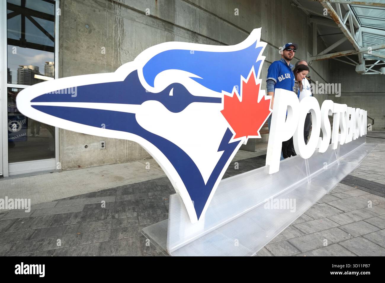 Toronto Blue Jays fans pose with a sign outside Rogers Centre ahead of ...