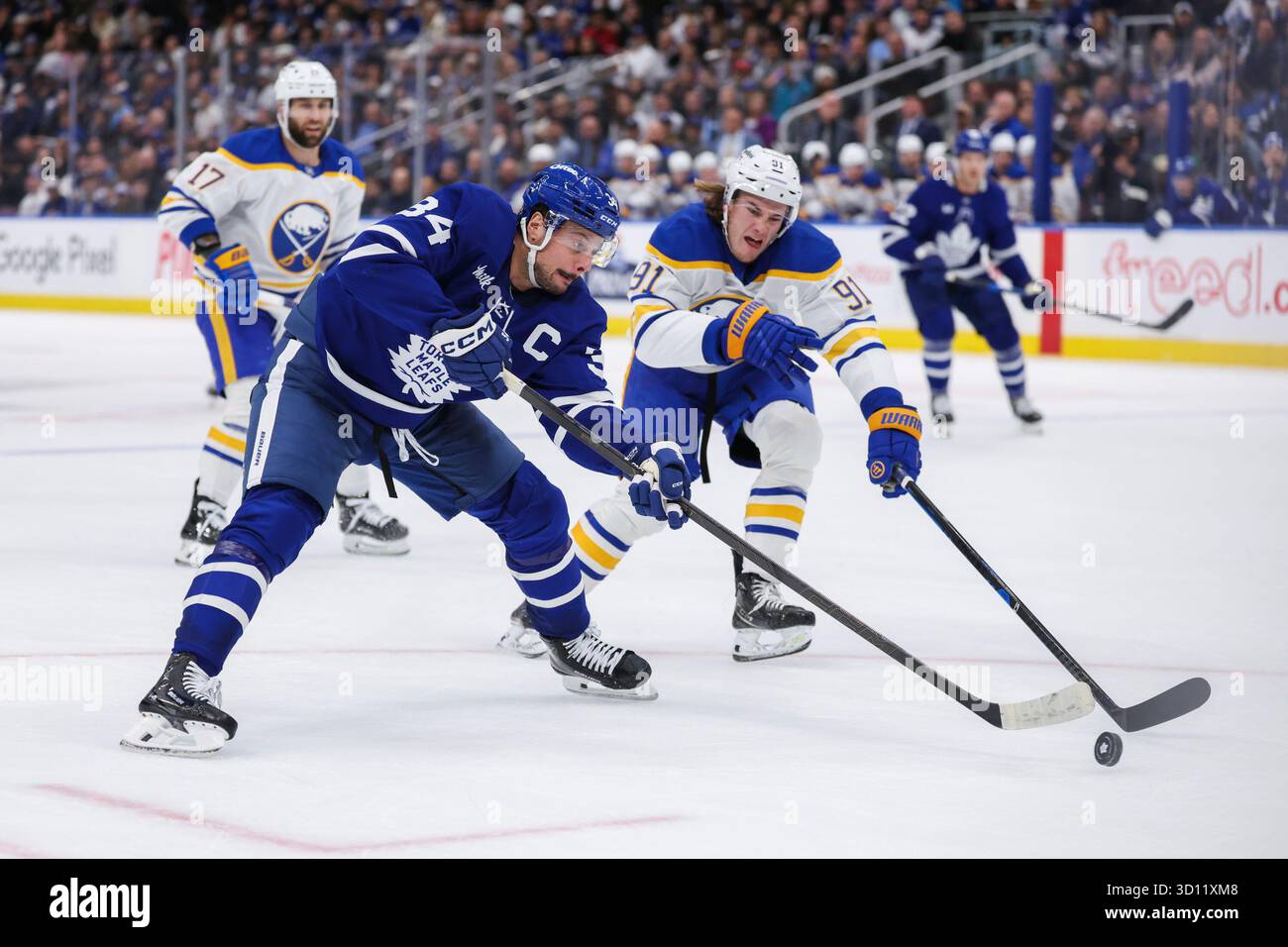 Toronto Maple Leafs' Auston Matthews battles for the puck with Buffalo ...