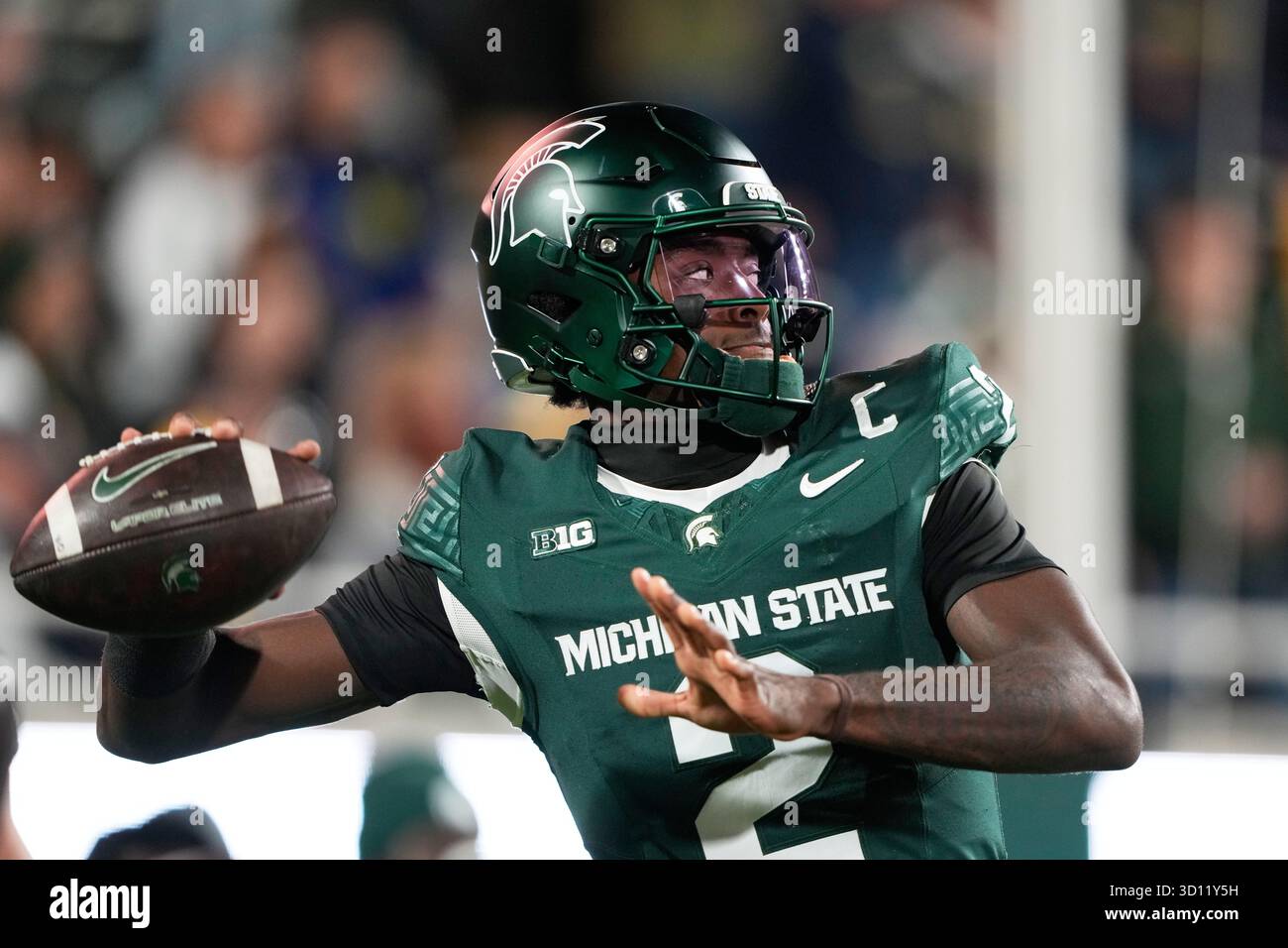 Michigan State quarterback Aidan Chiles warms up before an NCAA college ...