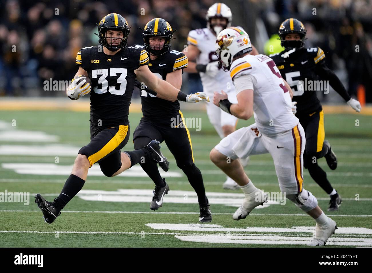 Iowa linebacker Cam Buffington (33) runs from Minnesota quarterback ...