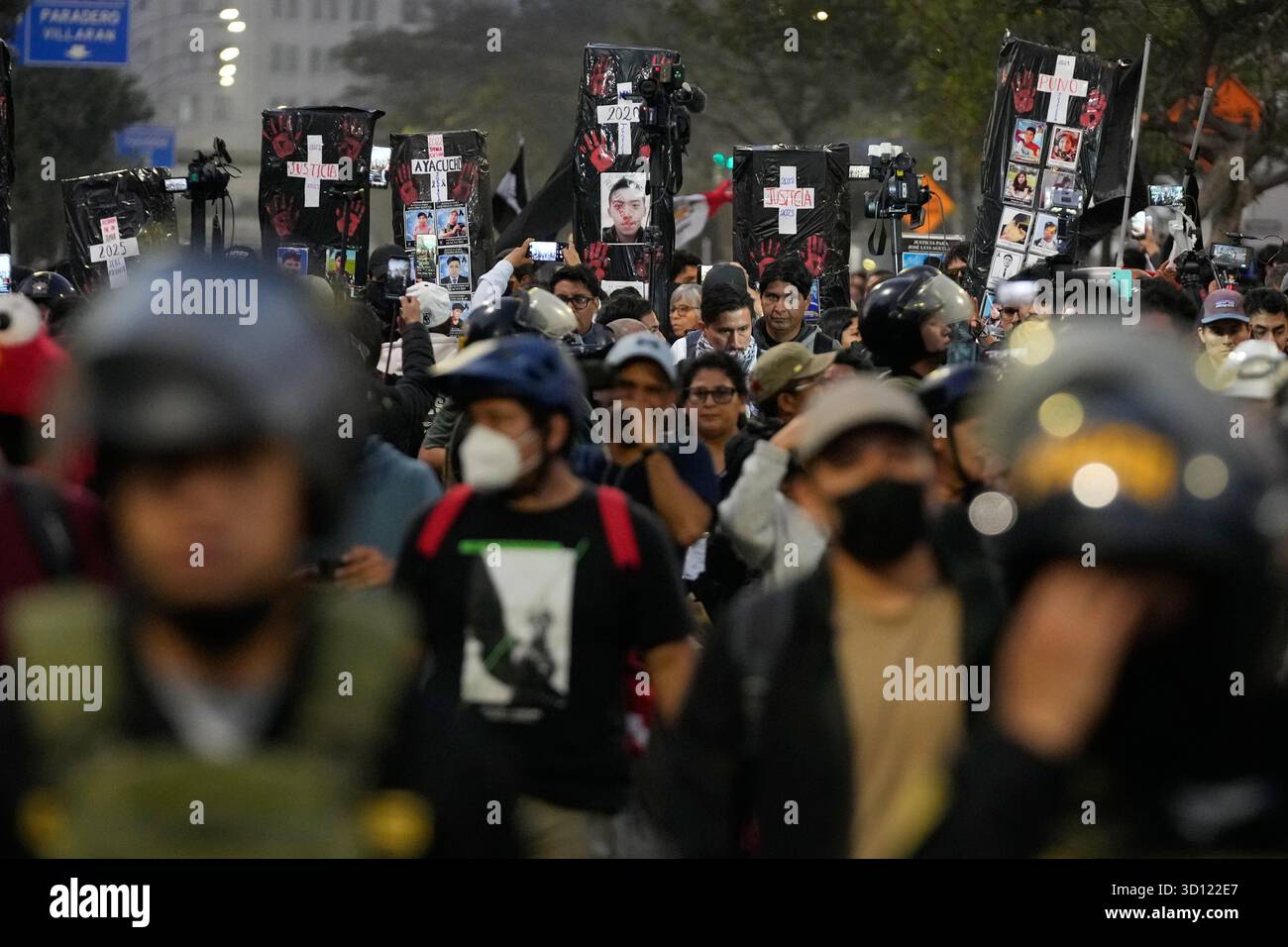 Demonstrators march carrying fake coffins representing victims of ...