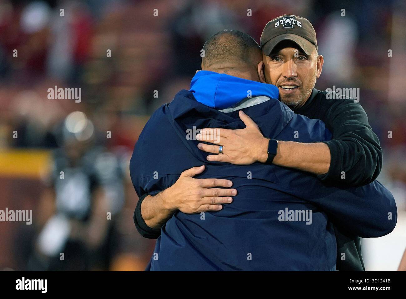 Iowa State head coach Matt Campbell hugs BYU head coach Kalani Sitake ...