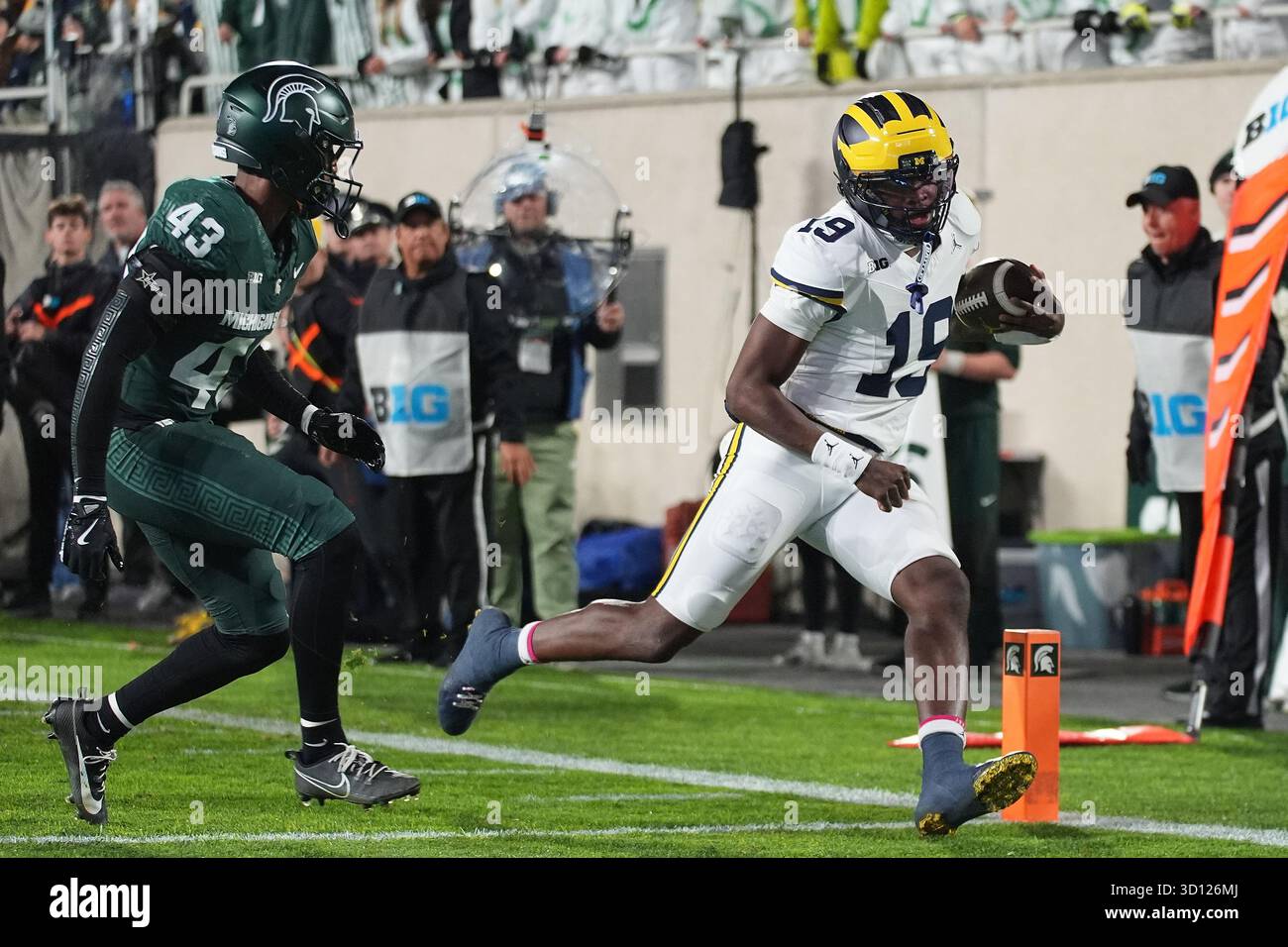 Michigan quarterback Bryce Underwood, right, runs past Michigan State ...