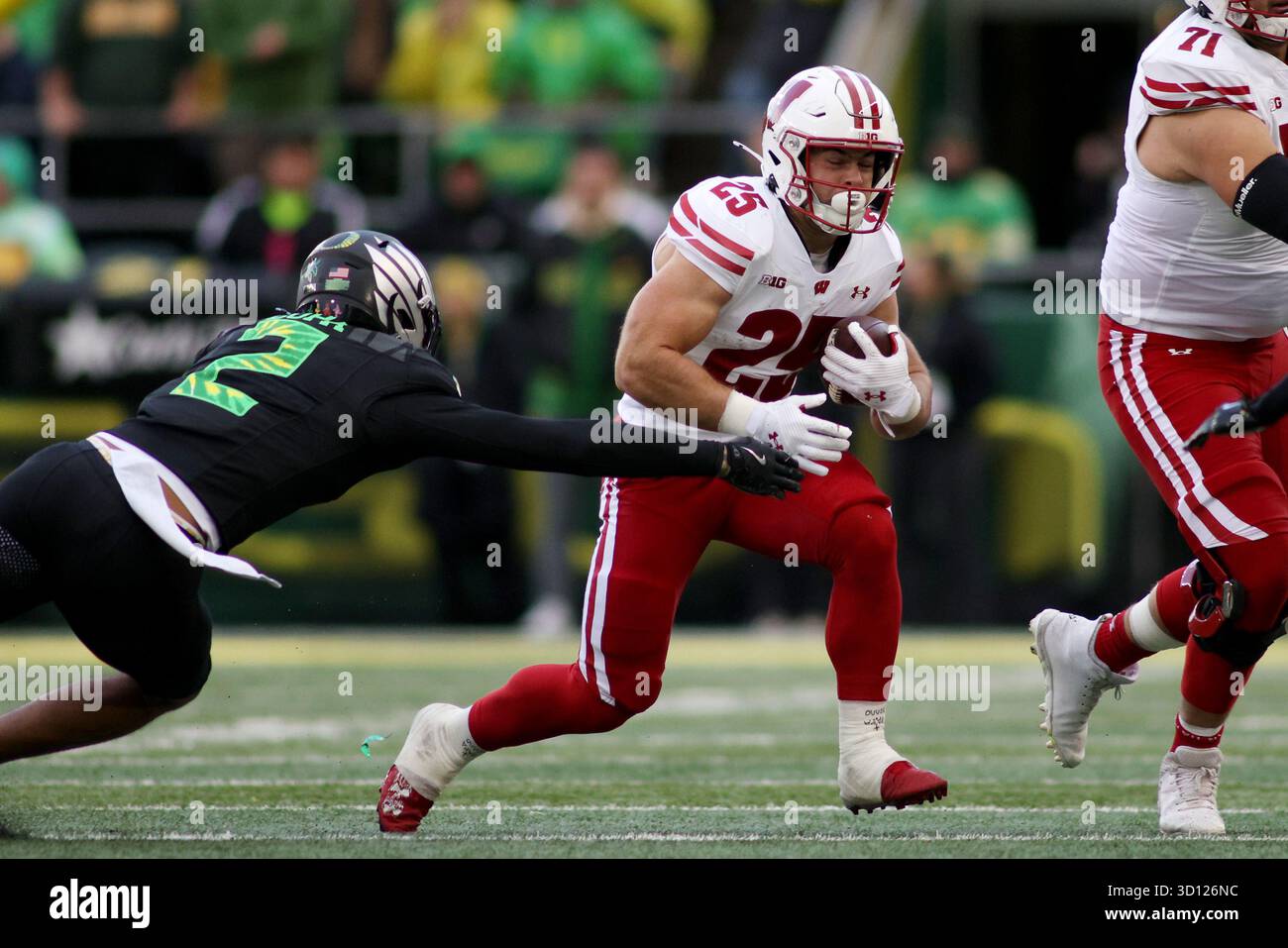 Wisconsin running back Cade Yacamelli (25) attempts to evade a tackle ...