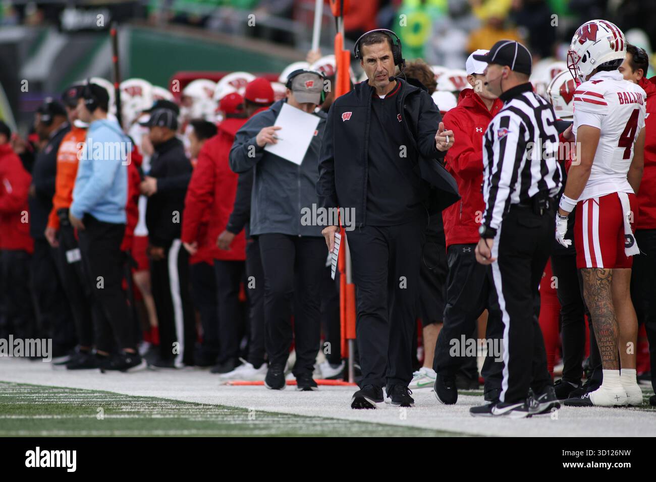 Wisconsin head coach Luke Fickell, third from front right, walks the ...