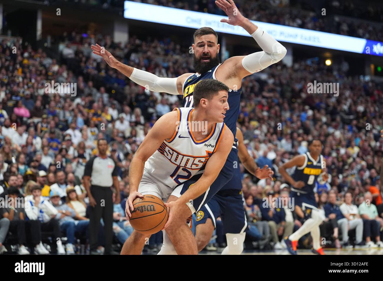 Phoenix Suns guard Collin Gillespie, front, looks to pass the ball as ...