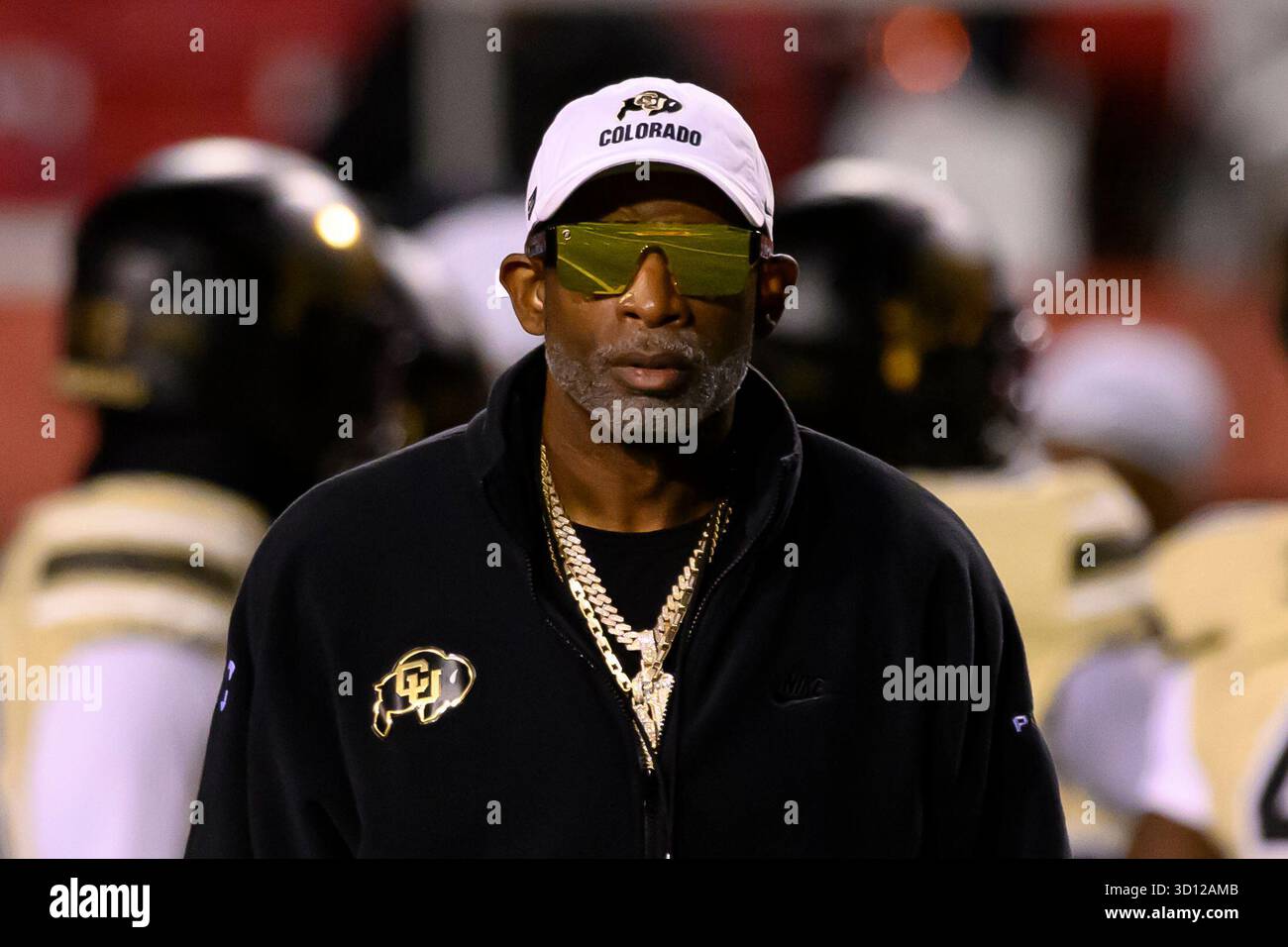 Colorado head coach Deion Sanders watches his players warm up before an ...
