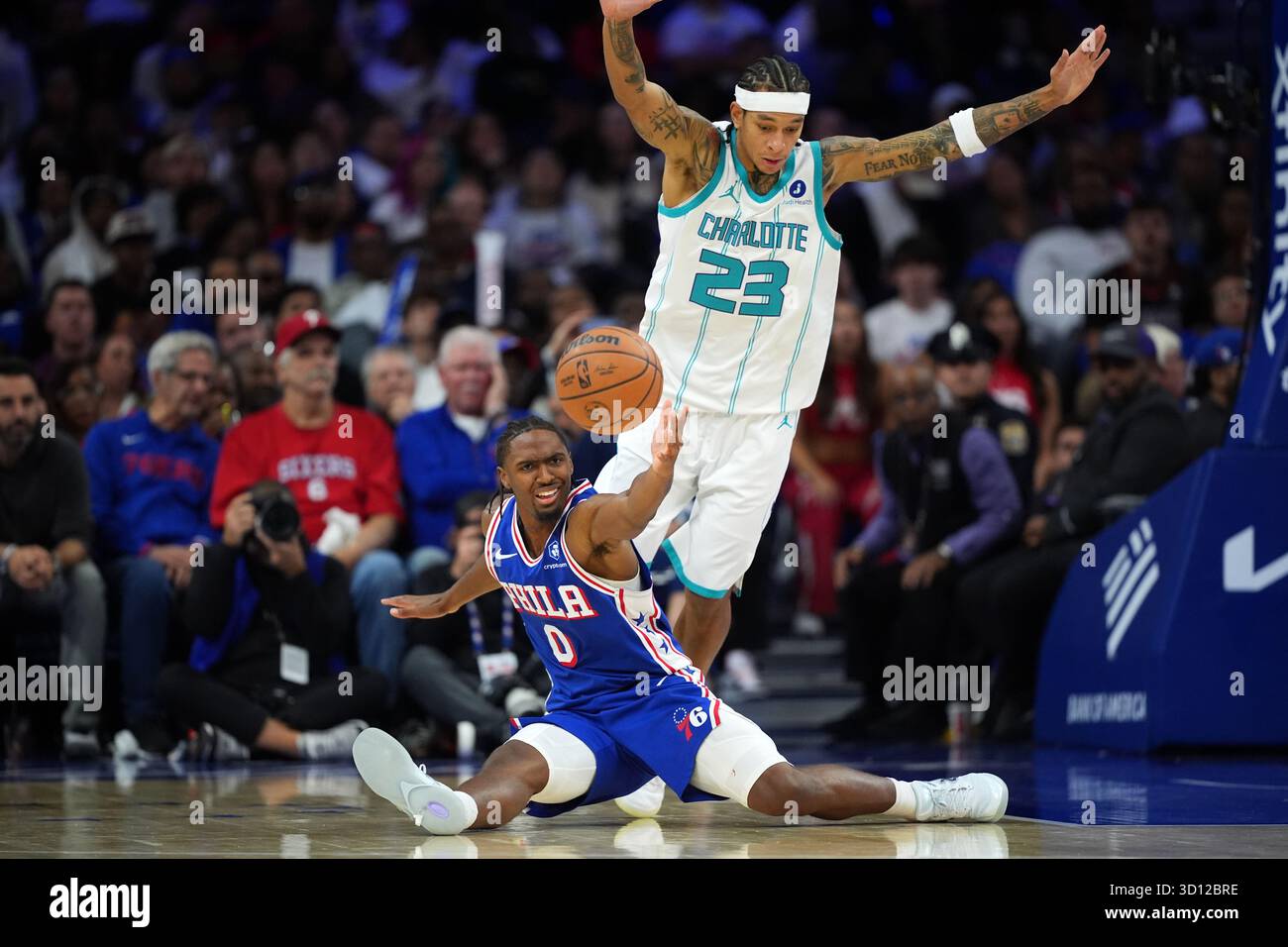 Philadelphia 76ers' Tyrese Maxey, bottom, tries to hang onto the ball ...