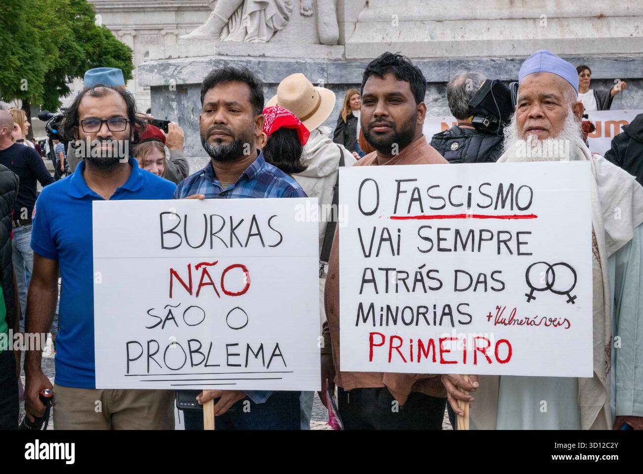 Protesters hold placards expressing their opinion at Rossio Square ...