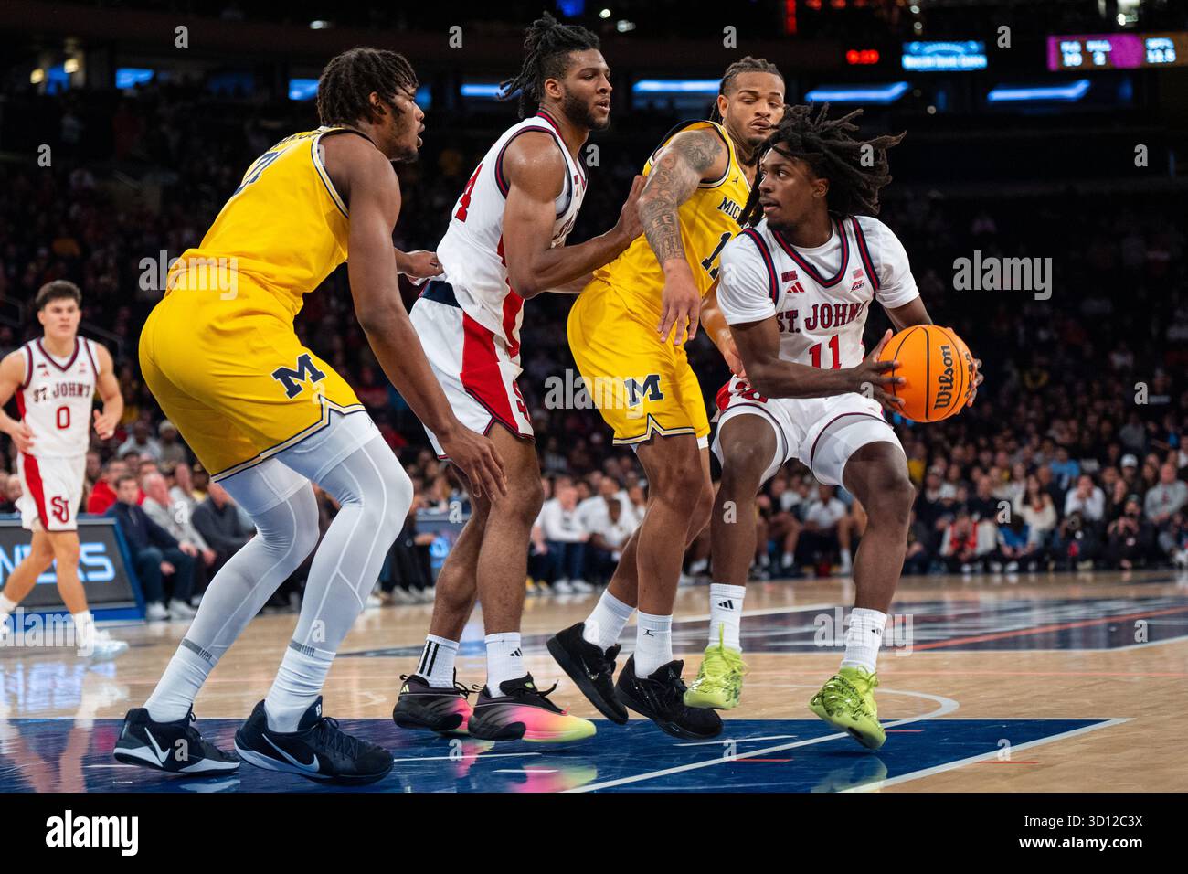 St. John guard Ian Jackson (11) searches for a pass during overtime of ...